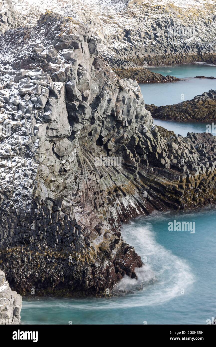 basalt columns on the cliffs of the village of Arnastapi Stock Photo ...