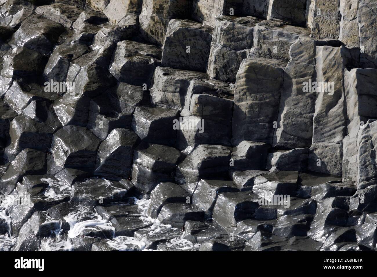 basalt columns on the cliffs of the village of Arnastapi Stock Photo ...
