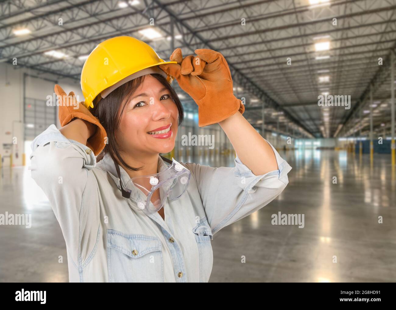 Hispanic Female Contractor Wearing Hard Hat Standing in Empty ...