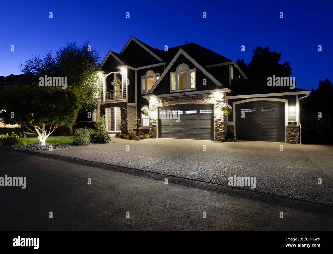 Luxury home exterior at night Stock Photo - Alamy