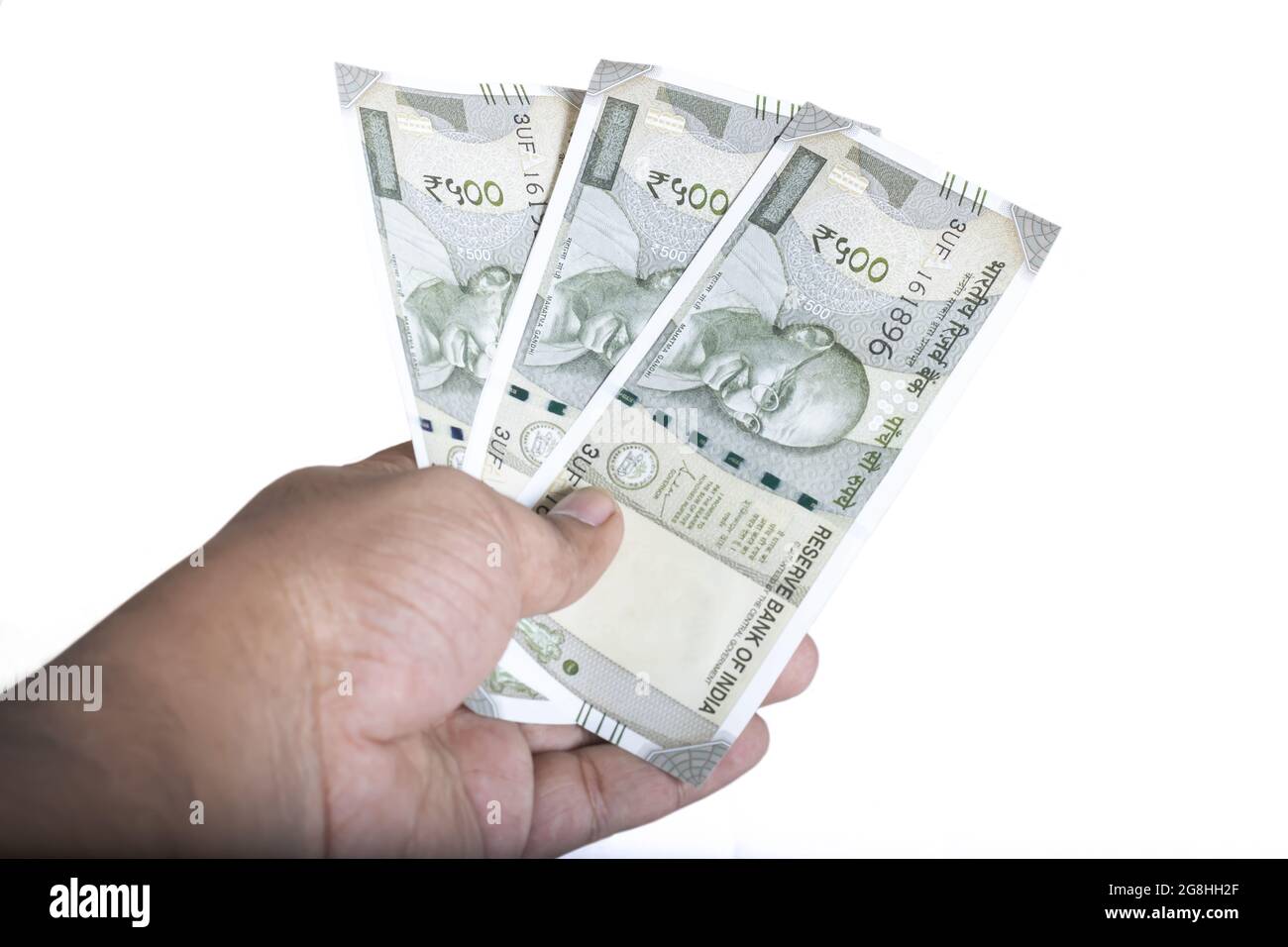 Hand holding Indian rupee bills with an isolated white background Stock ...