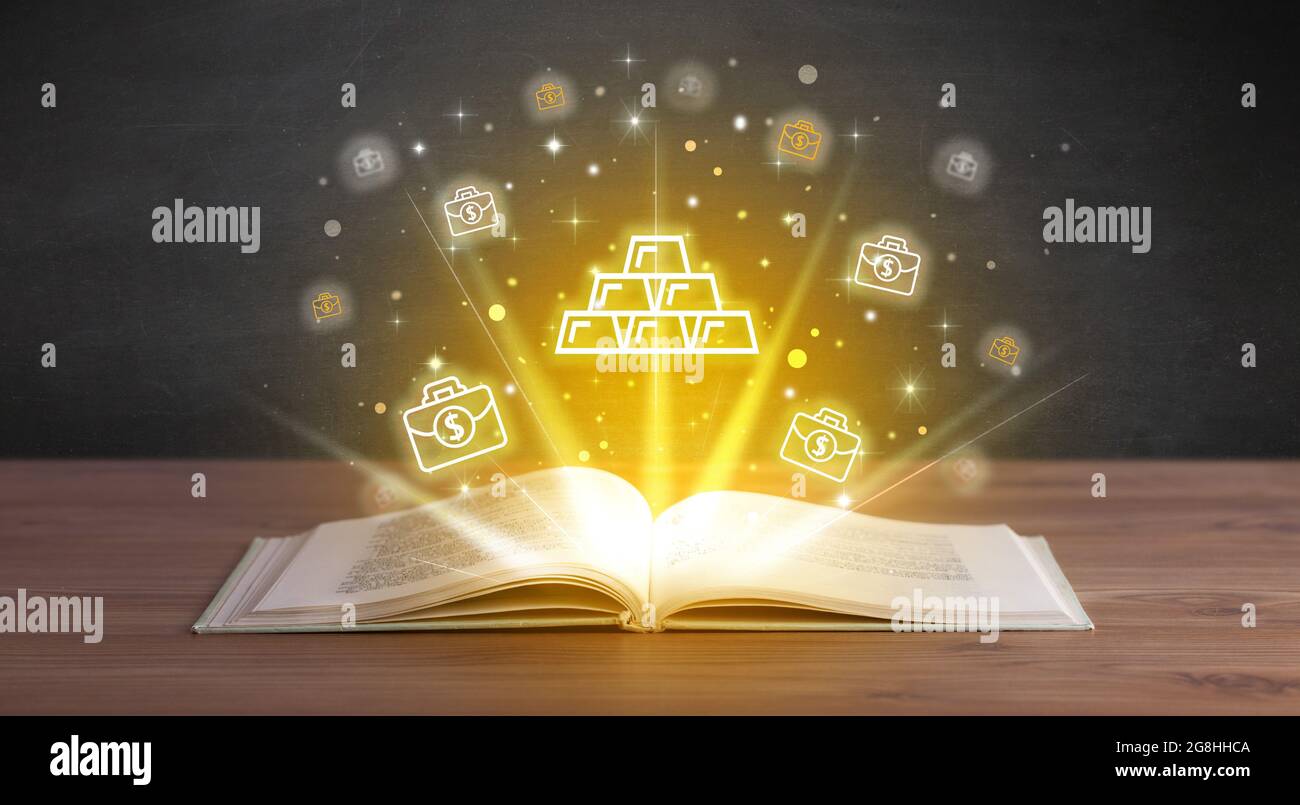 Open book with currency icons above Stock Photo - Alamy