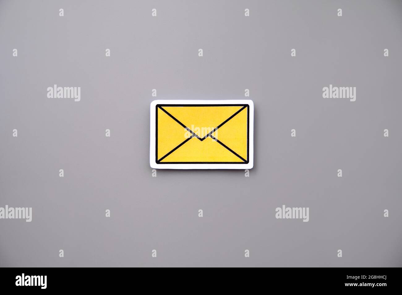 Yellow message sign or envelope icon against a grey background Stock ...