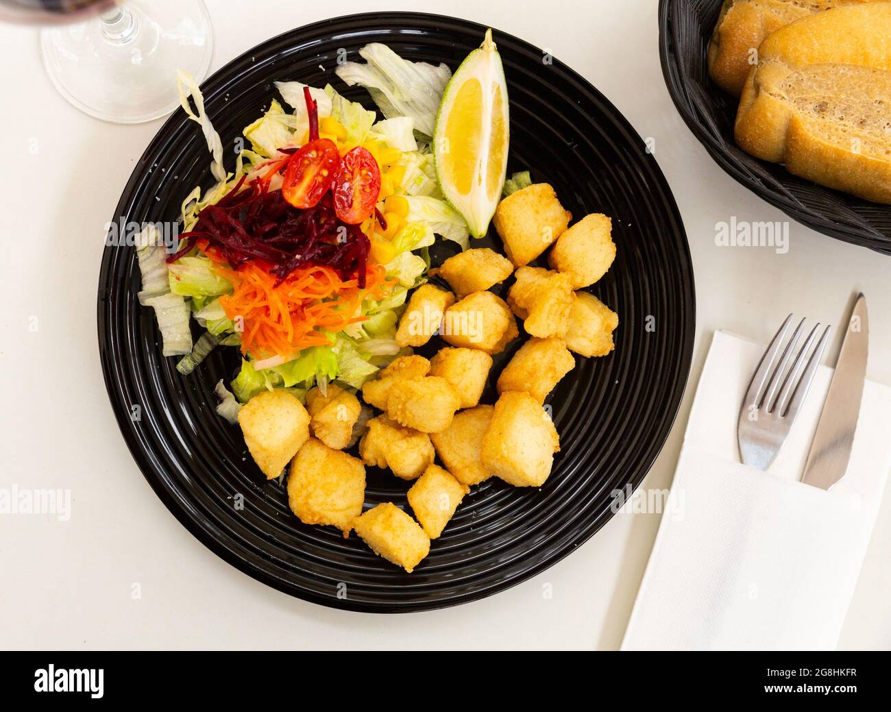 Pieces of fried cuttlefish breaded with vegetables Stock Photo - Alamy