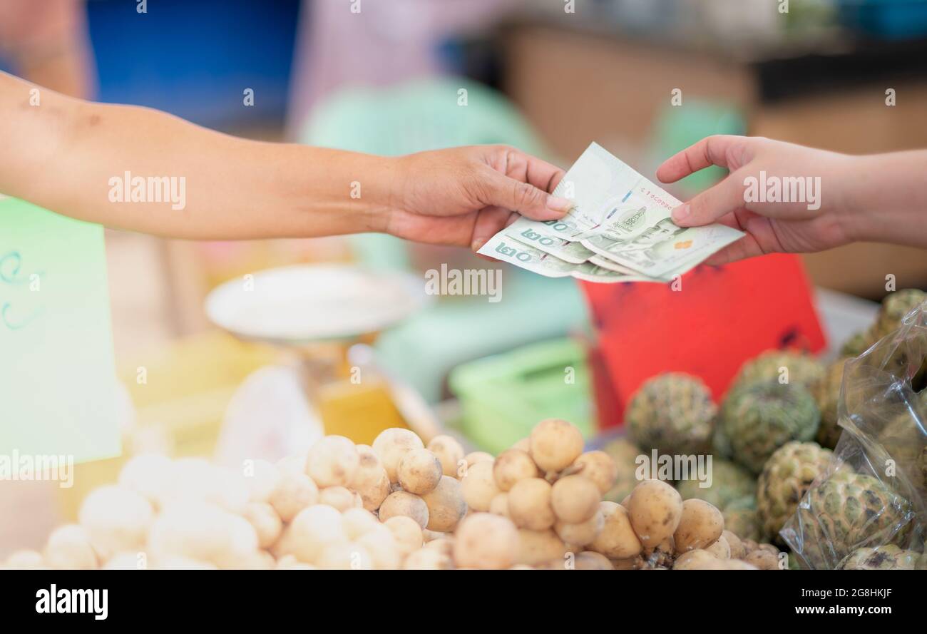 Female hand-counting bank paper for buy fresh fruit and vegetables at ...