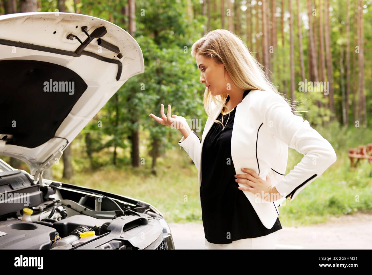 Blonde Caucasian woman not knowing how to fix the broken Stock Photo ...