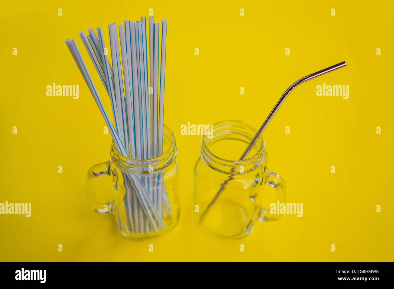 Steel drinking vs disposable straws on a yellow background. Zero waste ...