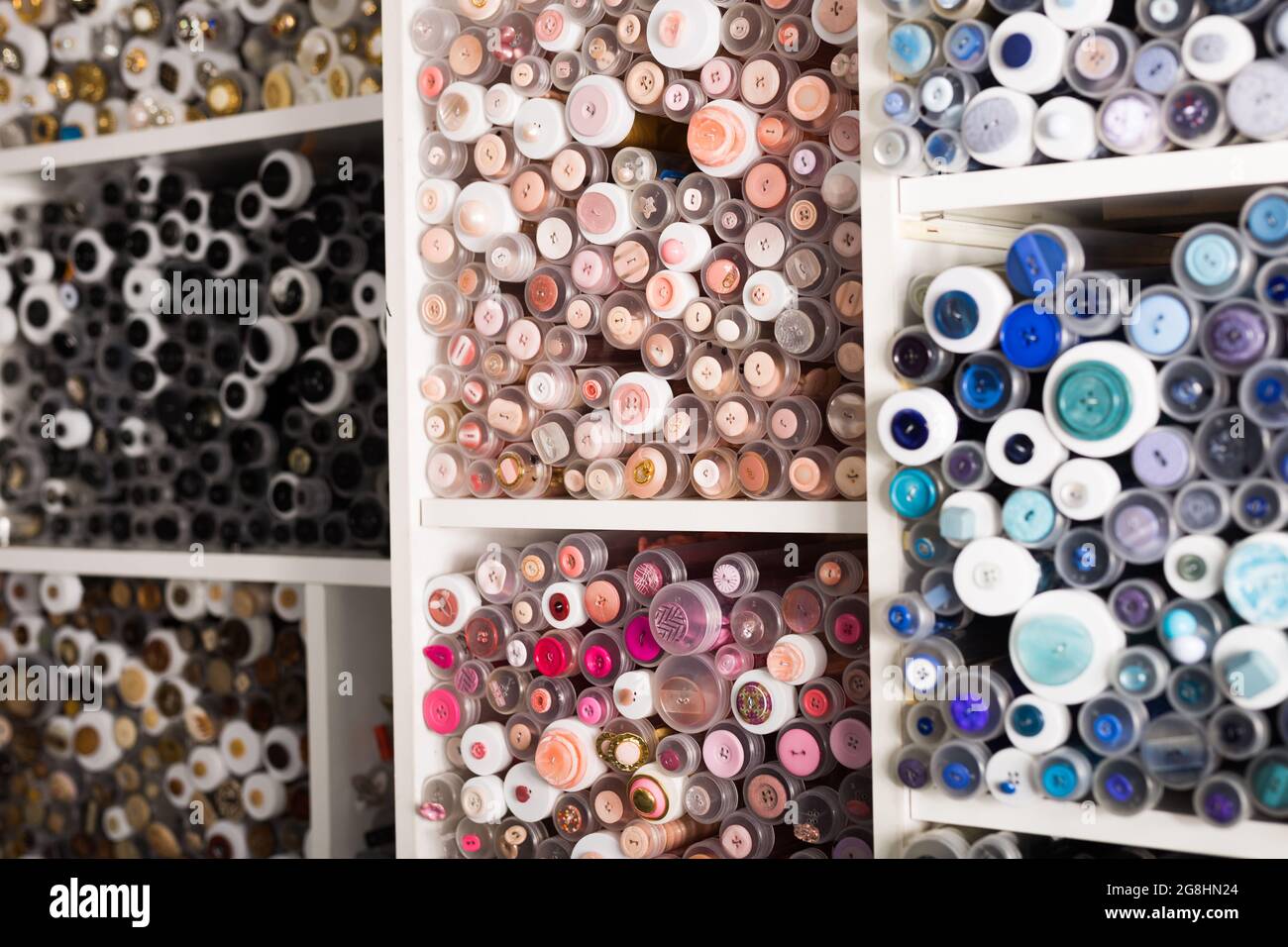 Buttons in tubes on store shelves Stock Photo - Alamy