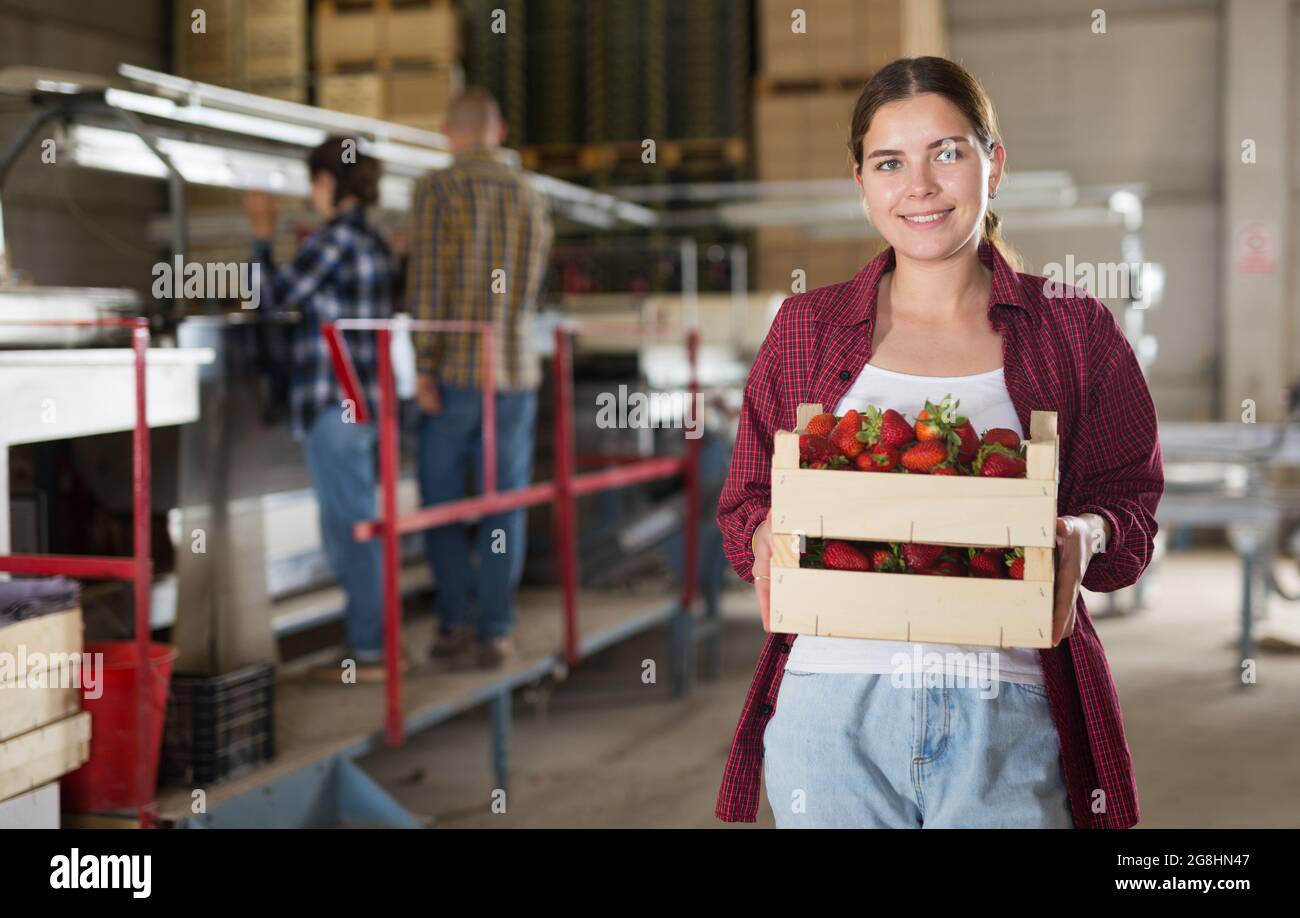 Woman holding strawberry box at fruit warehouse Stock Photo - Alamy