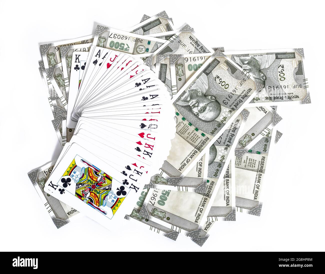 Pile of Indian rupee bills on an isolated white background with playing ...
