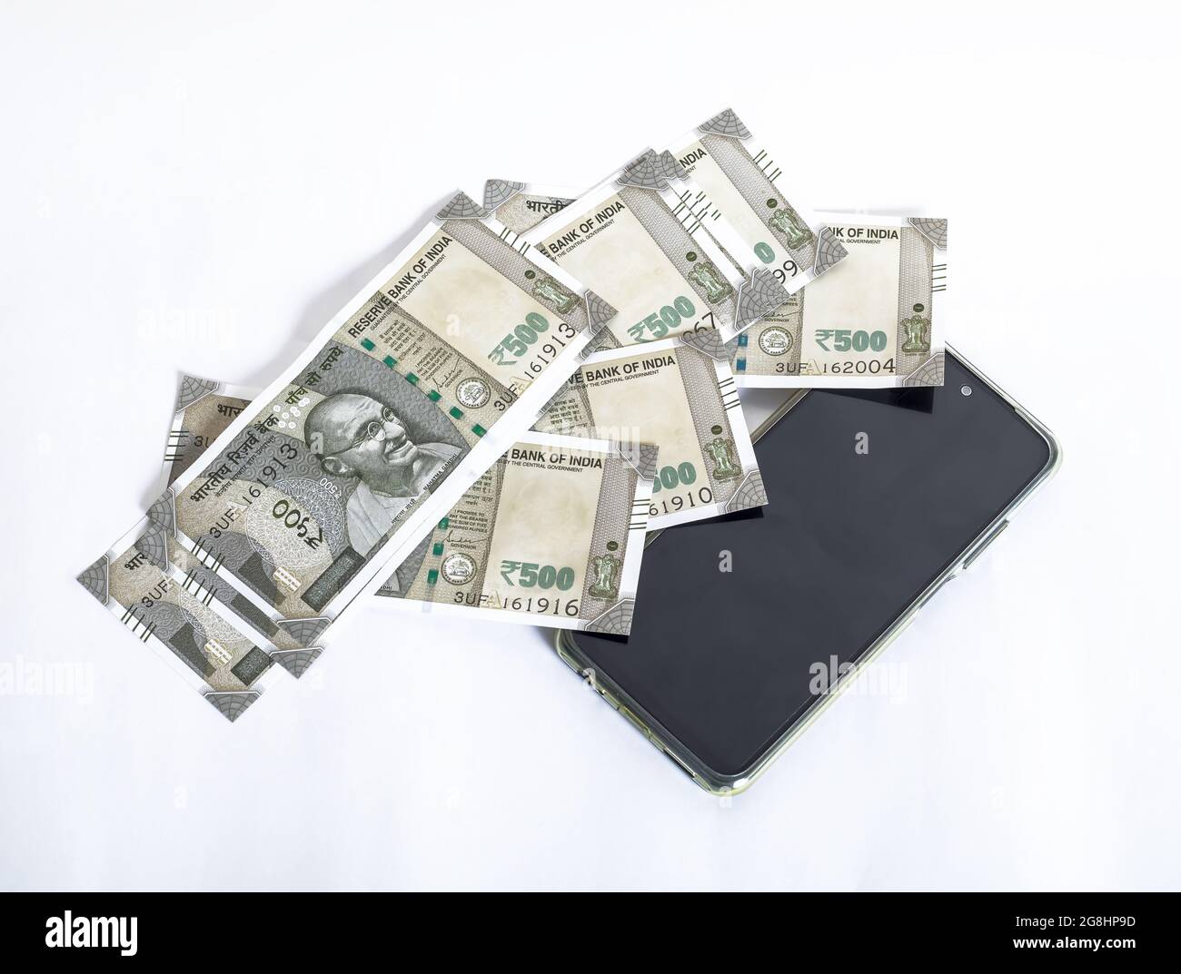 Pile of Indian rupee bills scattered on a white isolated background ...