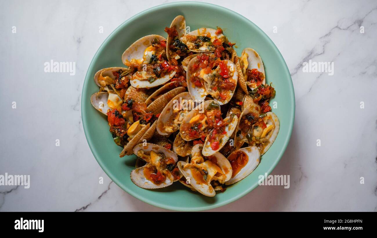 Lala or saltwater clams cooked spicy sambal with shrimp paste or ...