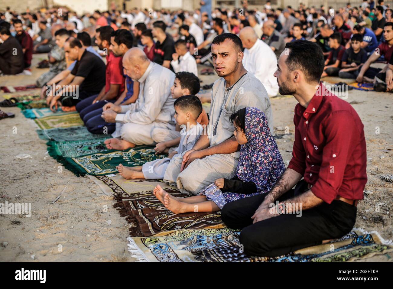 Palestinian Muslims perform prayers in a square, on the first day of ...