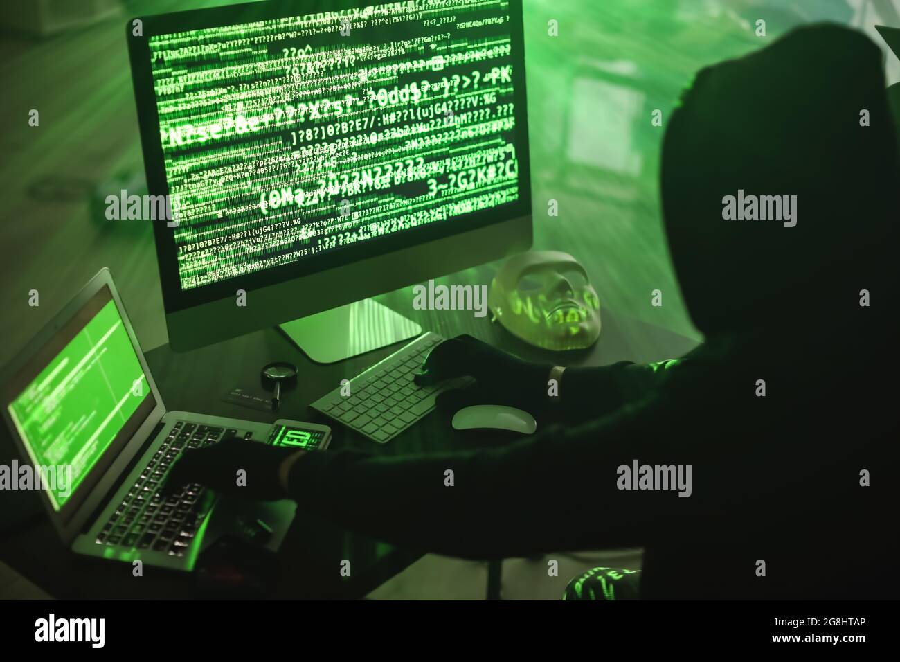Hacker using computers in dark room Stock Photo - Alamy