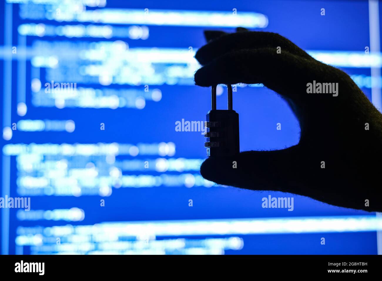Hand of hacker with padlock near screen of computer Stock Photo - Alamy