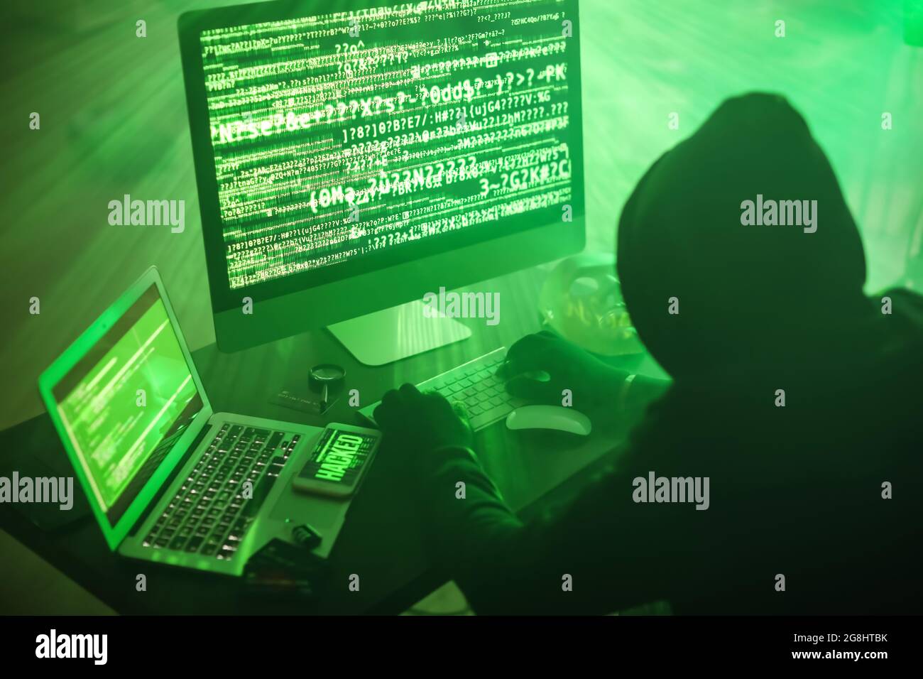 Hacker using computers in dark room Stock Photo - Alamy