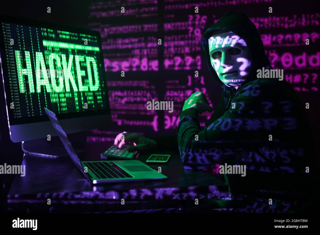 Hacker using computer in dark room Stock Photo - Alamy