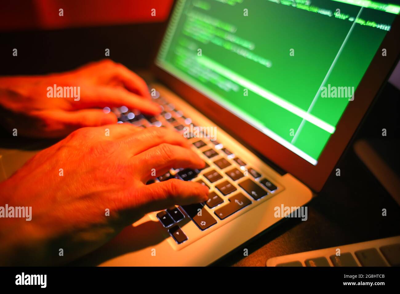 Hacker using computer in dark room Stock Photo - Alamy