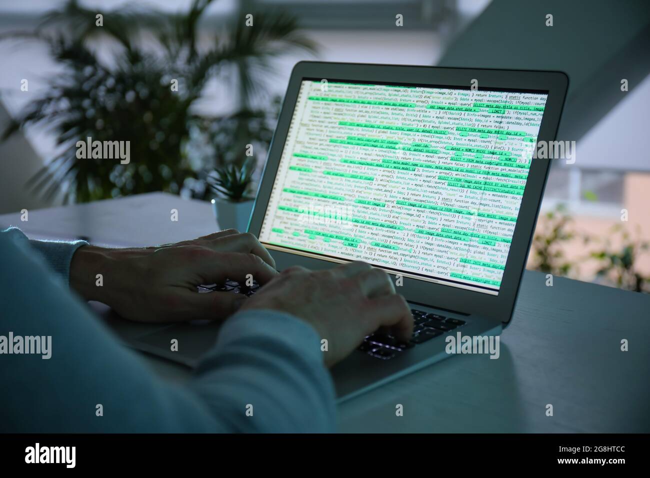 Hacker using computer in dark room Stock Photo - Alamy