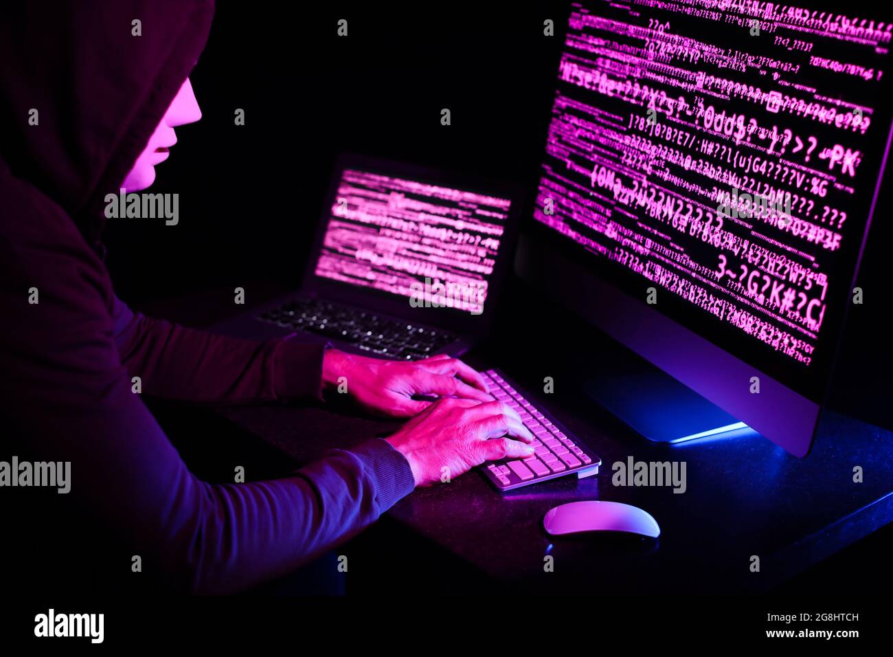 Hacker using computers in dark room Stock Photo - Alamy