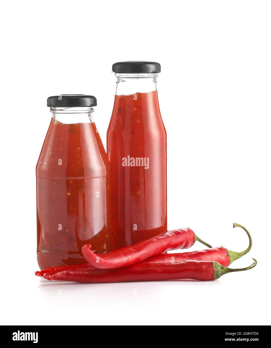 Bottles of chili sauce on white background Stock Photo - Alamy