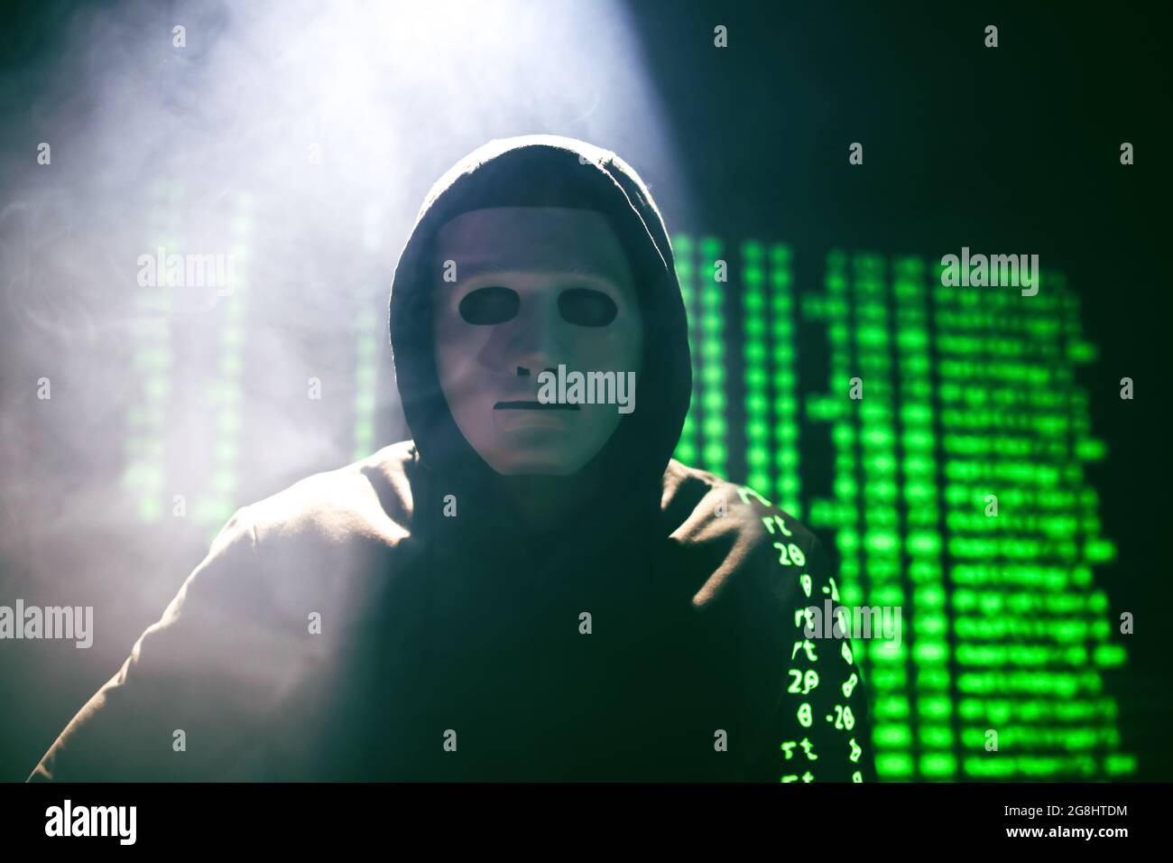 Hacker in mask on dark background Stock Photo - Alamy