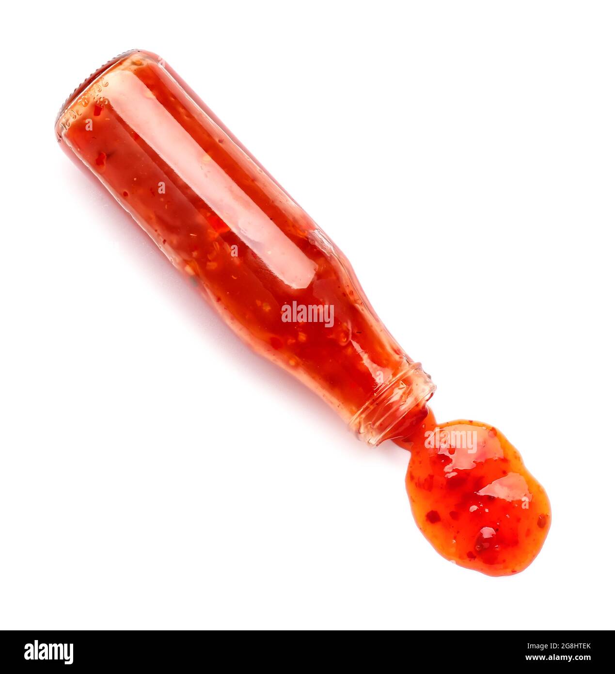 Bottle with spilled chili sauce on white background Stock Photo - Alamy