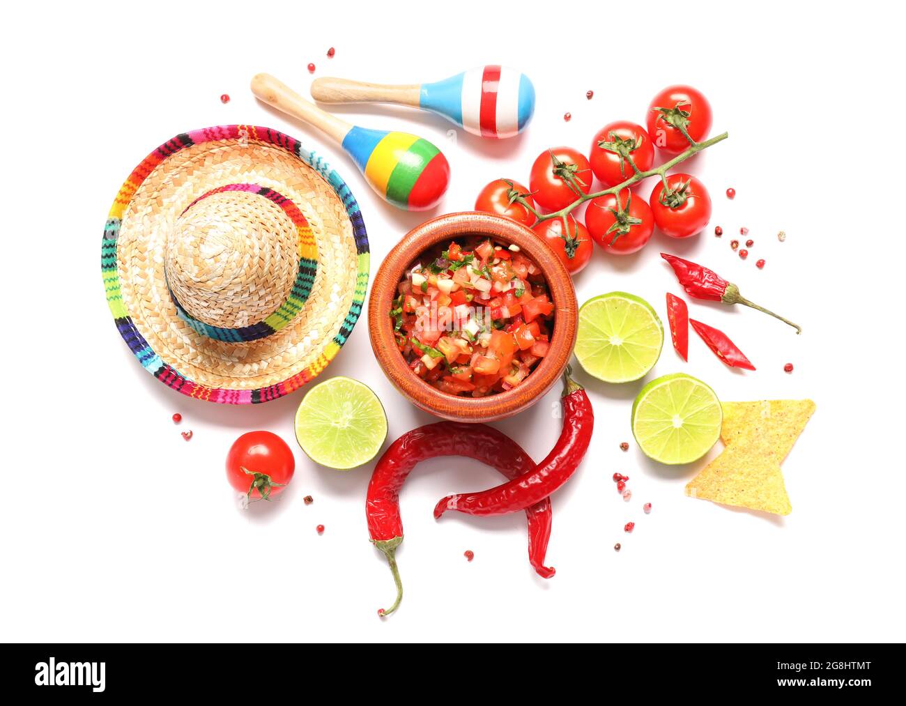 Bowl of tasty salsa sauce and symbols of Mexico on white background ...
