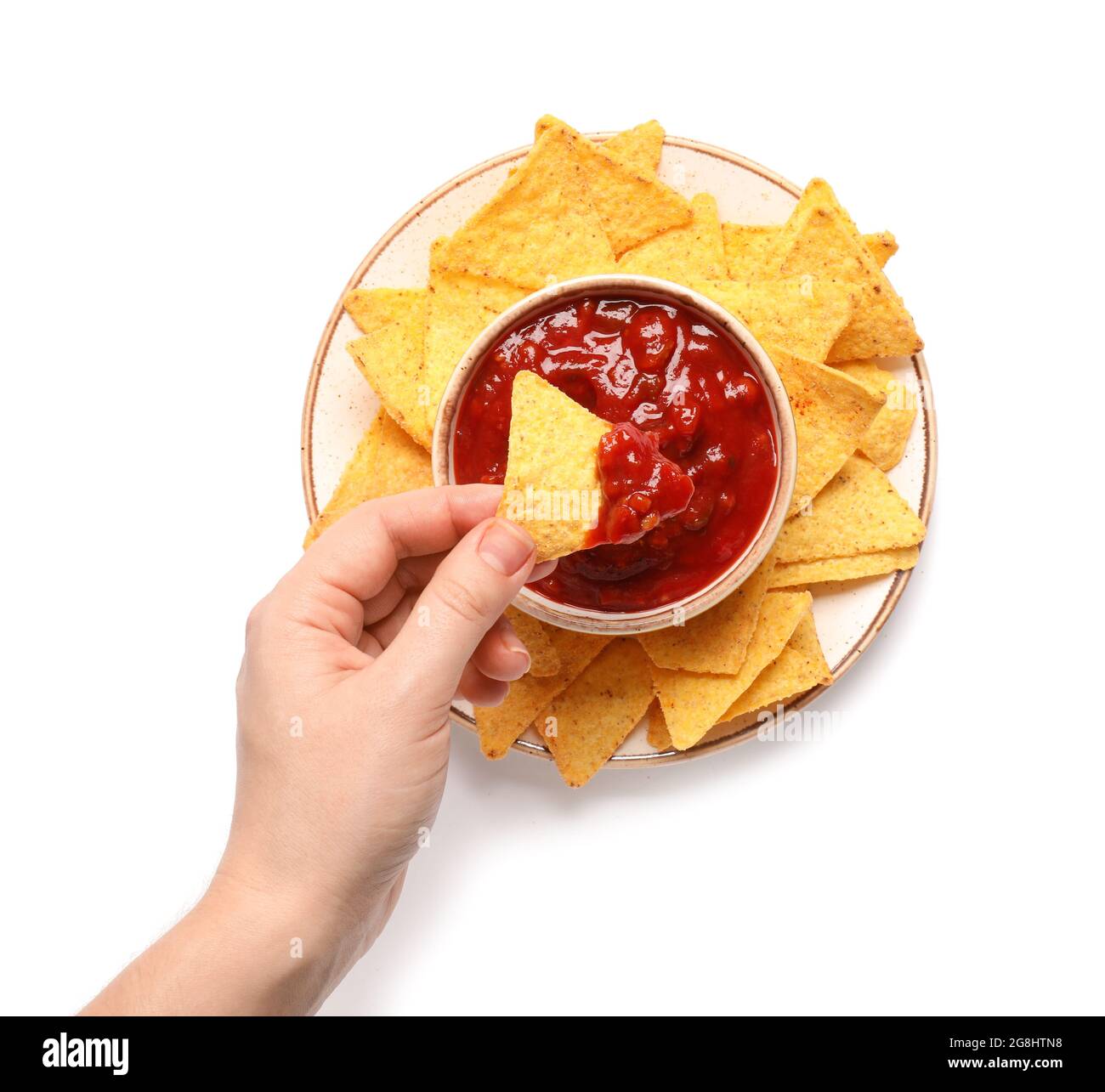 Woman dipping nachos into tasty salsa sauce Stock Photo - Alamy