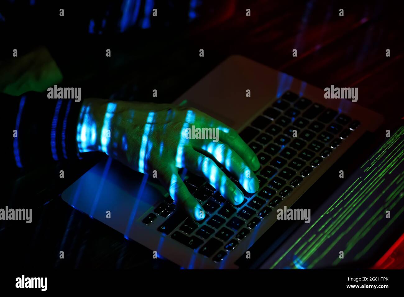 Hacker using computer in dark room Stock Photo - Alamy