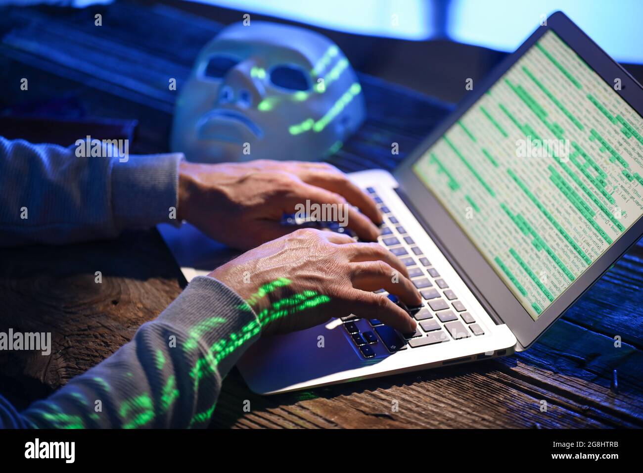 Hacker using computer in dark room Stock Photo - Alamy