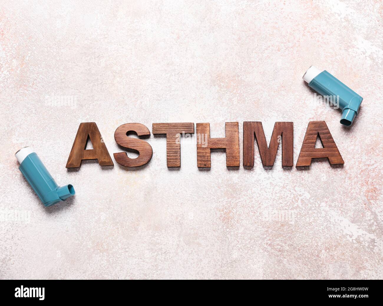 Modern inhalers and word ASTHMA on grunge background Stock Photo - Alamy