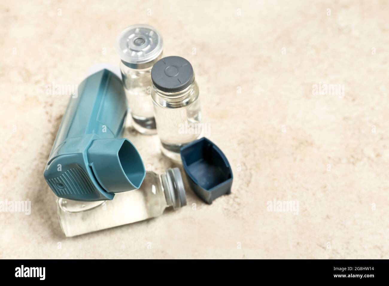Modern inhaler and ampules on grunge background Stock Photo - Alamy
