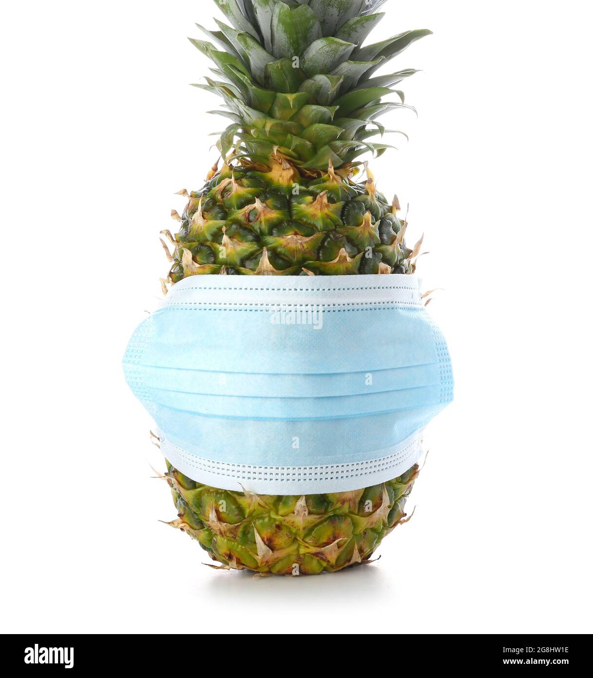 Fresh pineapple in medical mask on white background Stock Photo - Alamy