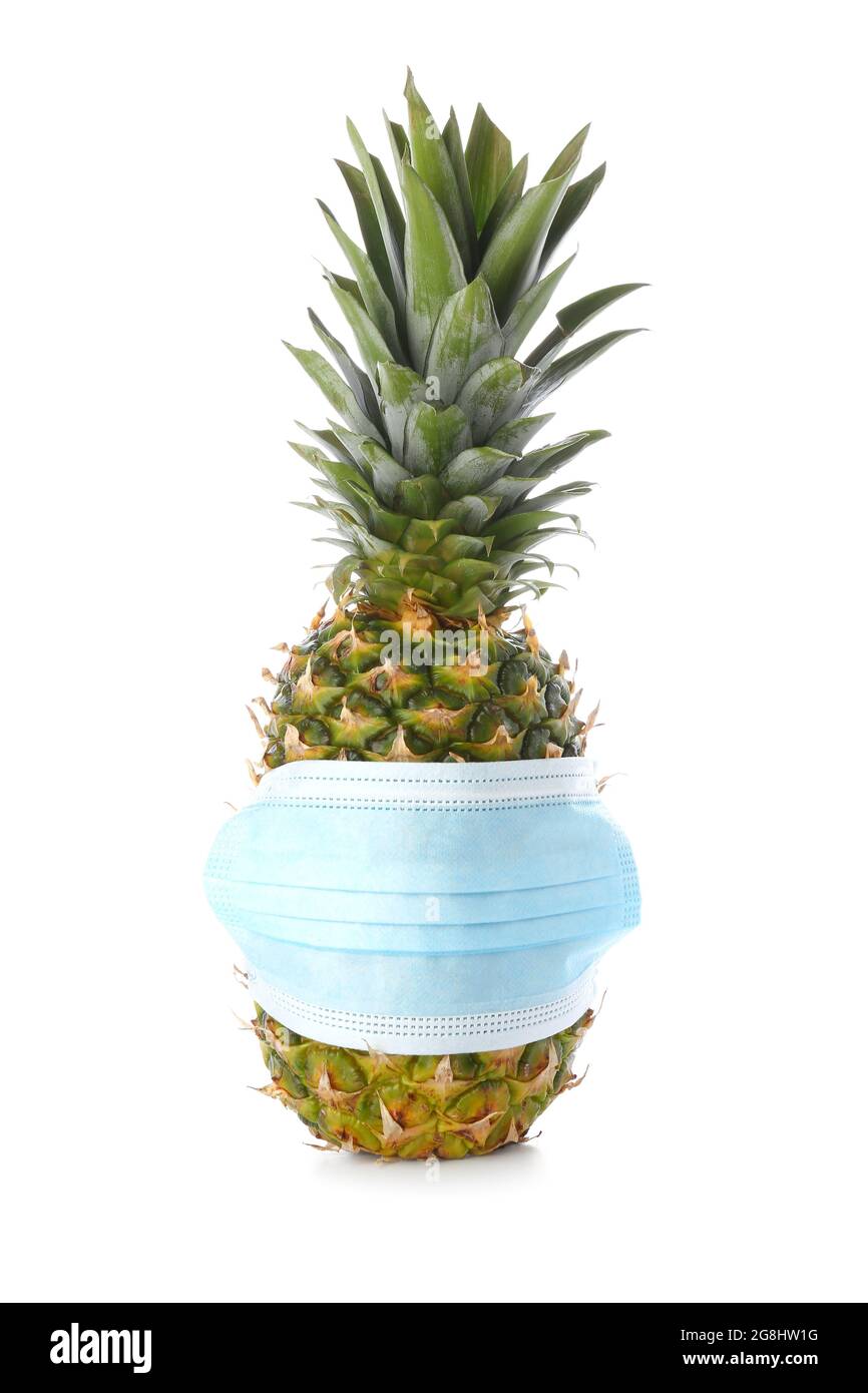 Fresh pineapple in medical mask on white background Stock Photo - Alamy