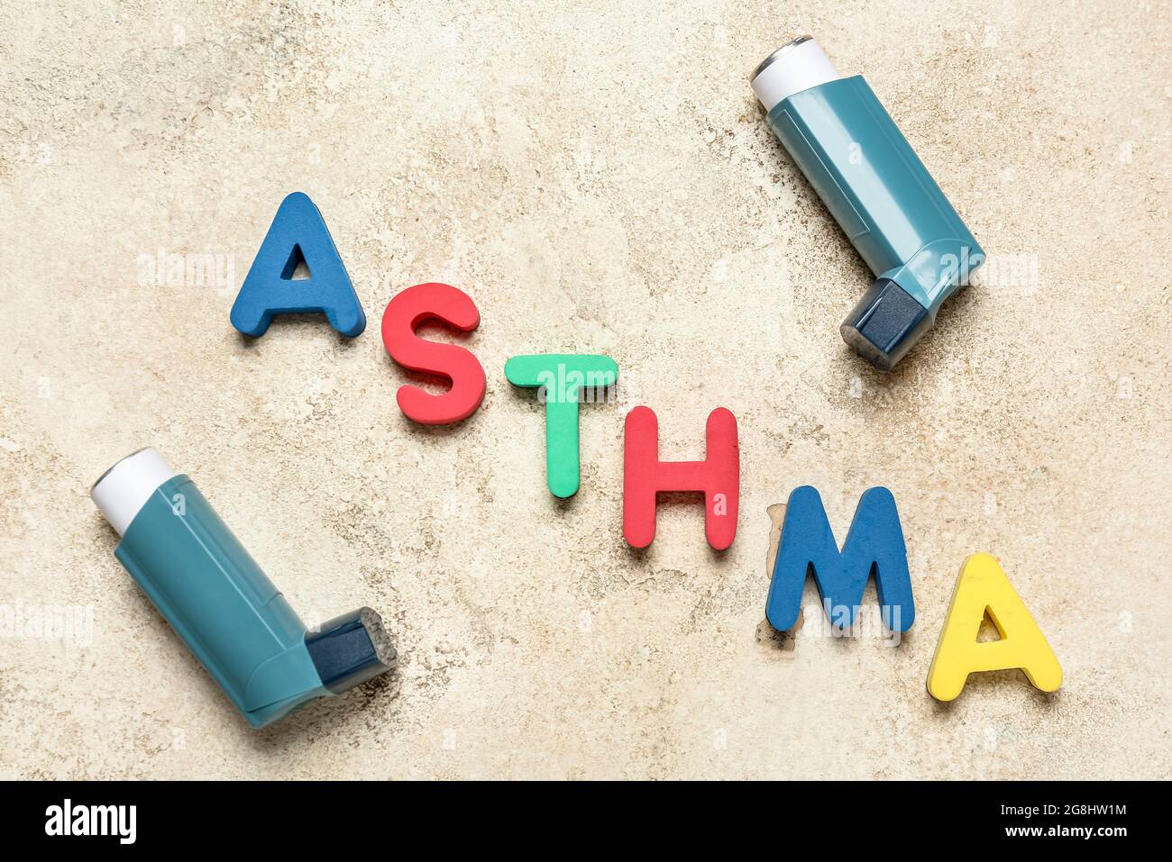 Modern inhalers and word ASTHMA on grunge background Stock Photo - Alamy