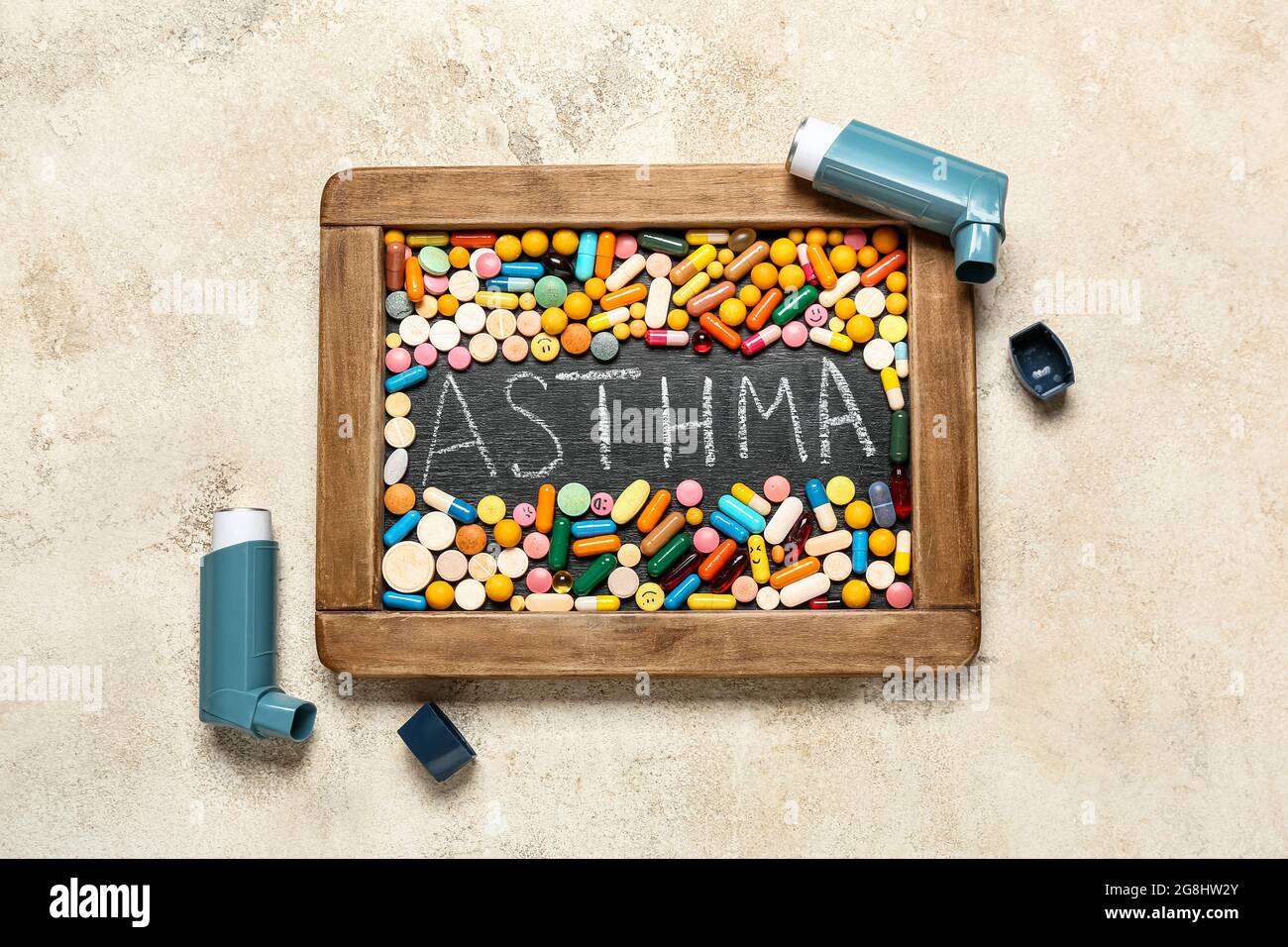 Chalkboard with word ASTHMA, pills and inhalers on grunge background ...