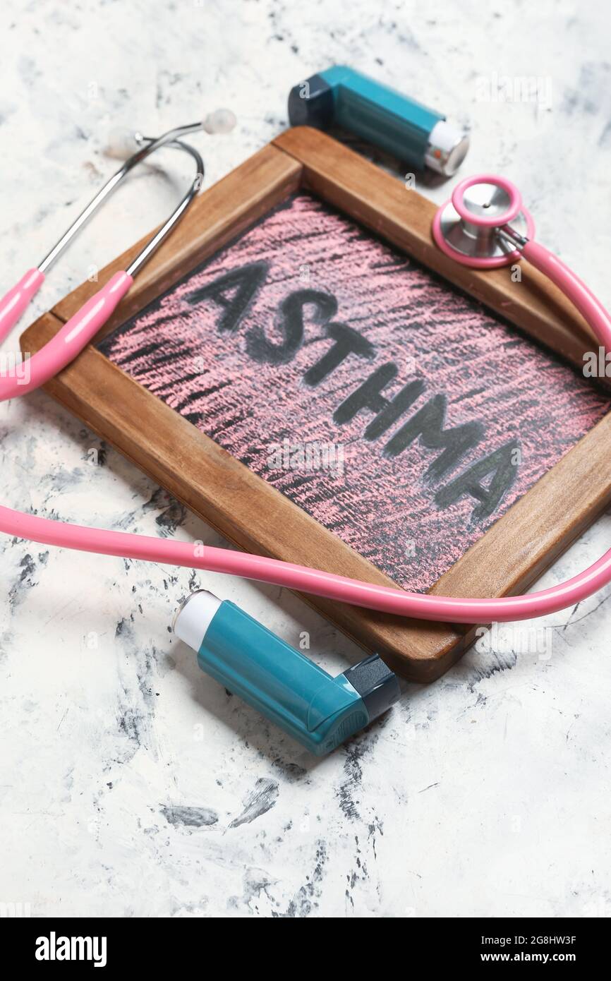 Chalkboard with word ASTHMA, inhalers and stethoscope on grunge ...