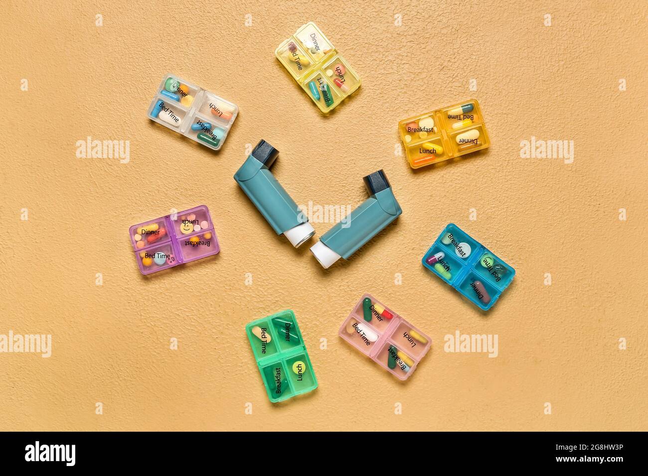 Modern inhalers and pills on color background Stock Photo - Alamy