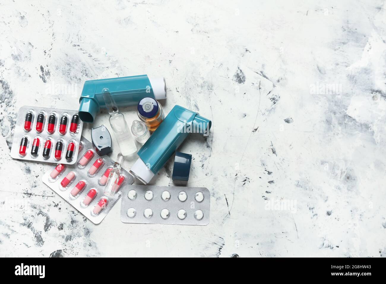 Inhalers and medicines on grunge background Stock Photo - Alamy