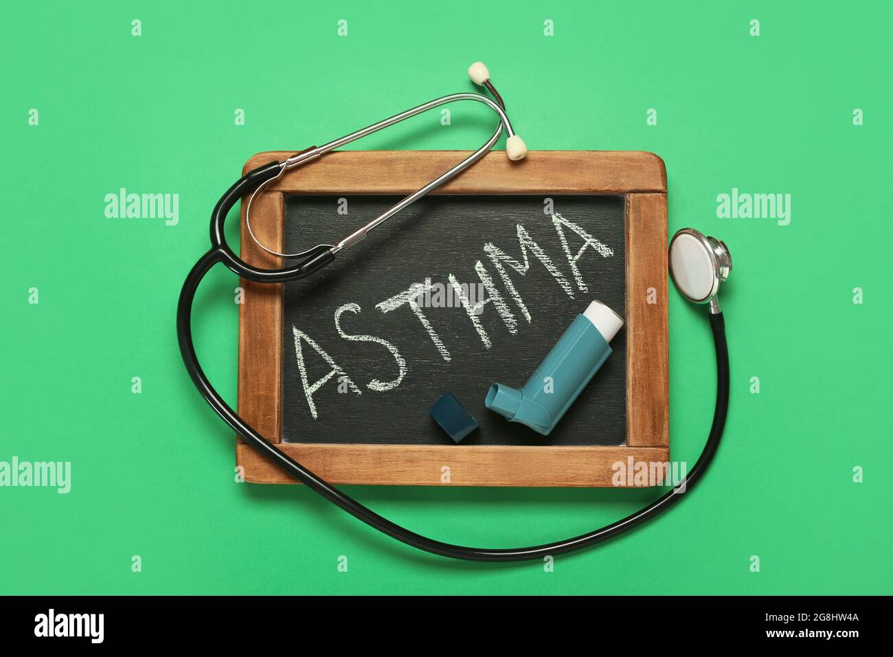 Chalkboard with word ASTHMA, inhaler and stethoscope on color ...