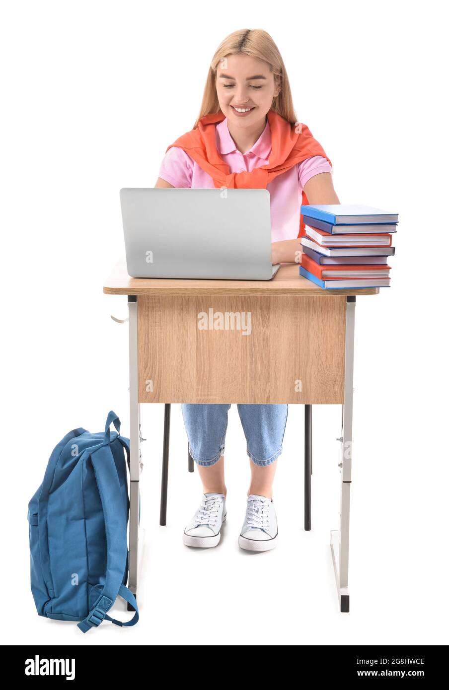 Student with laptop sitting at desk on white background Stock Photo - Alamy