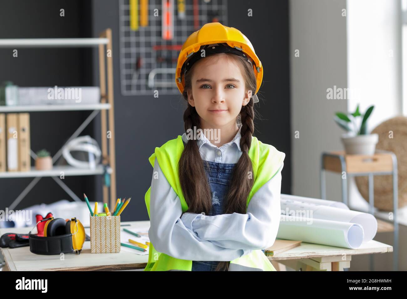 Cute little architect working in office Stock Photo - Alamy