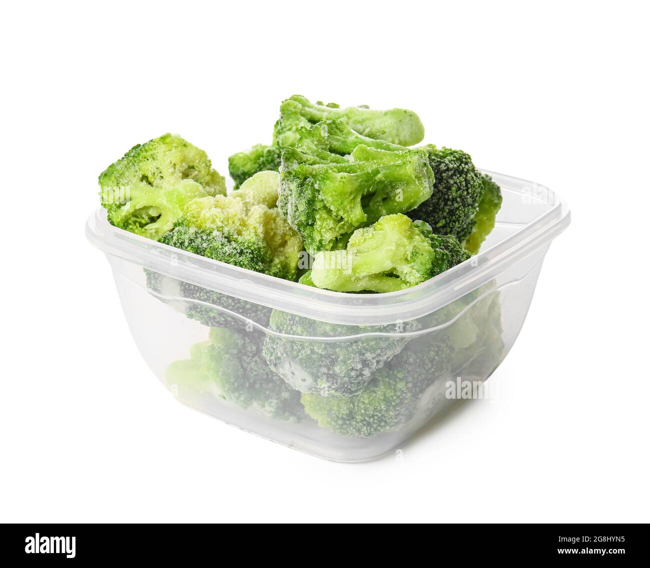 Container with frozen broccoli on white background Stock Photo - Alamy