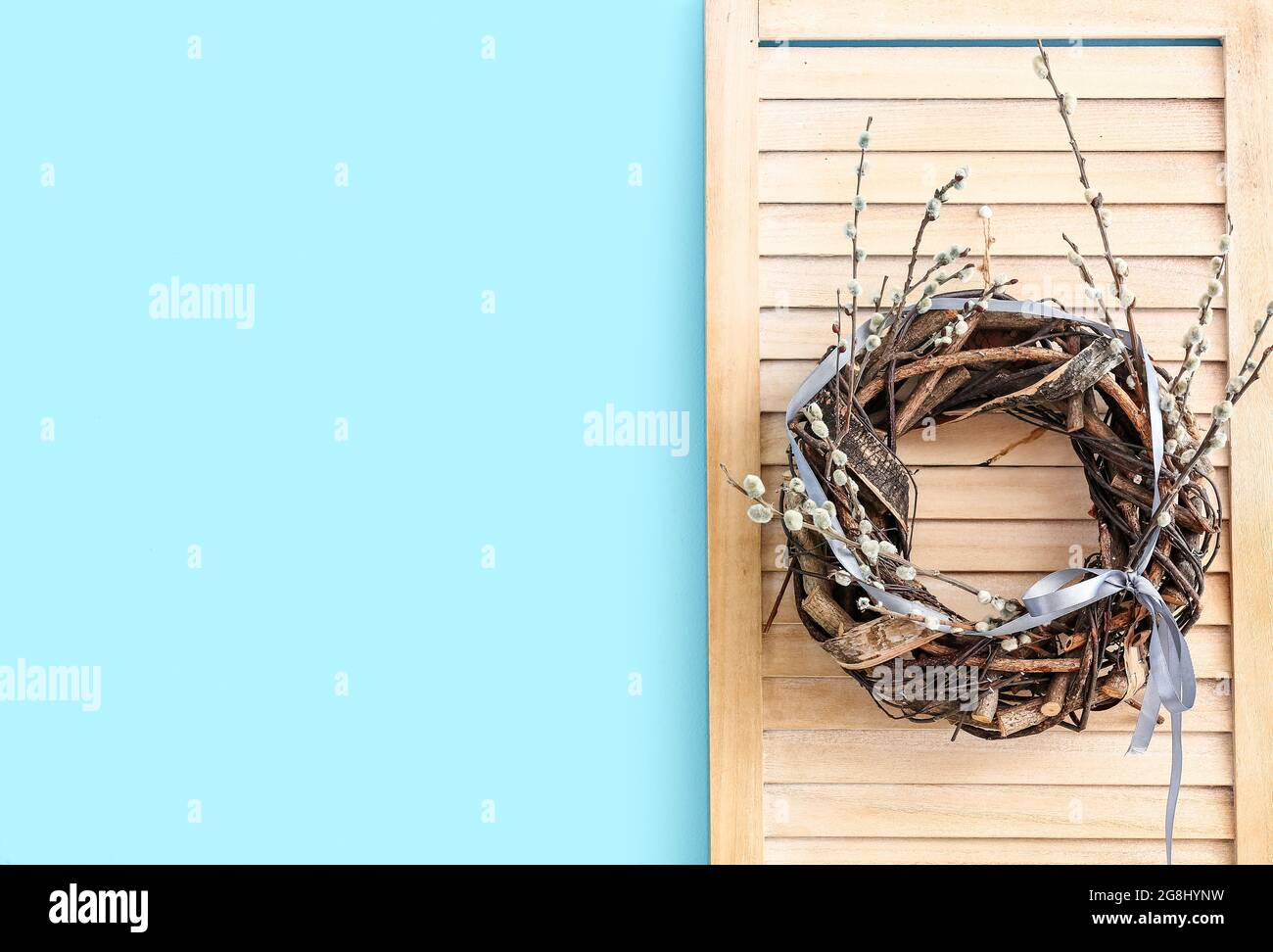 Wreath with willow branches on folding screen near color wall Stock ...