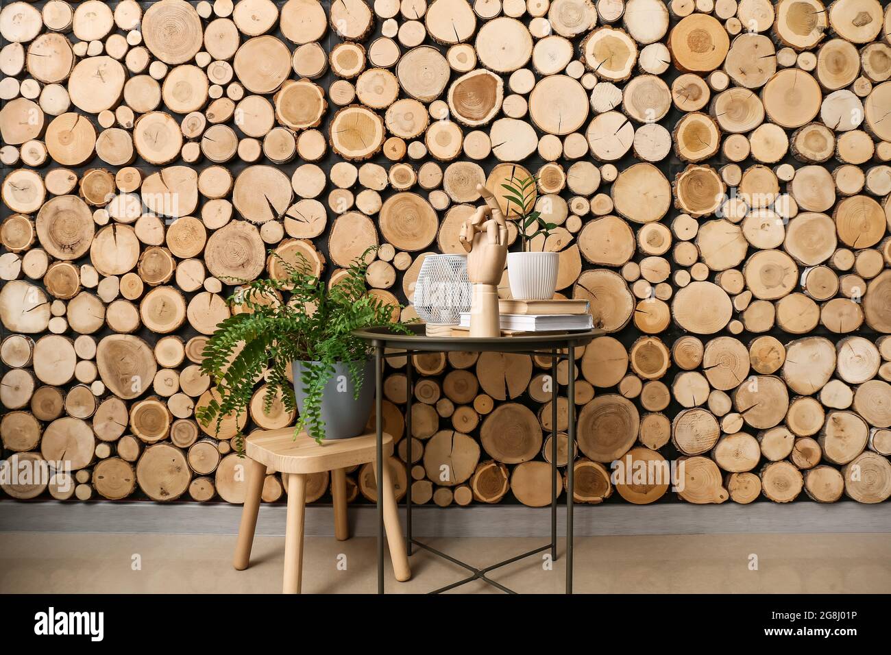 Interior of modern stylish room with table and stool near wooden wall ...