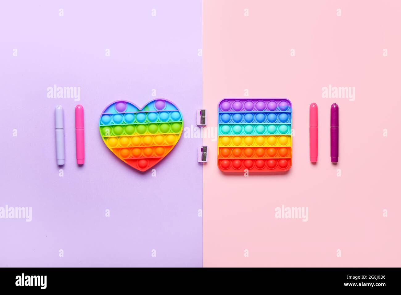 Pop it fidget toys and stationery on color background Stock Photo - Alamy