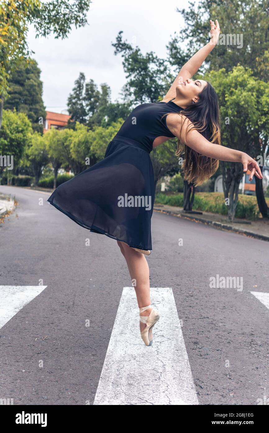 Latin female ballet dancer dancing on a crosswalk Stock Photo - Alamy