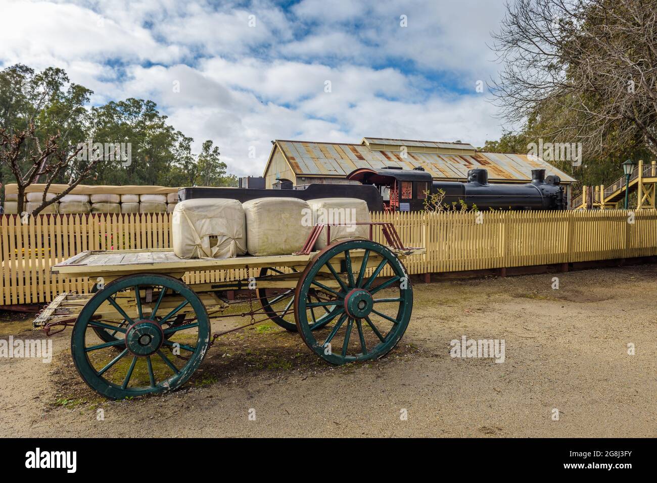 A single historic wagon stands on a dirt main street in the old ...