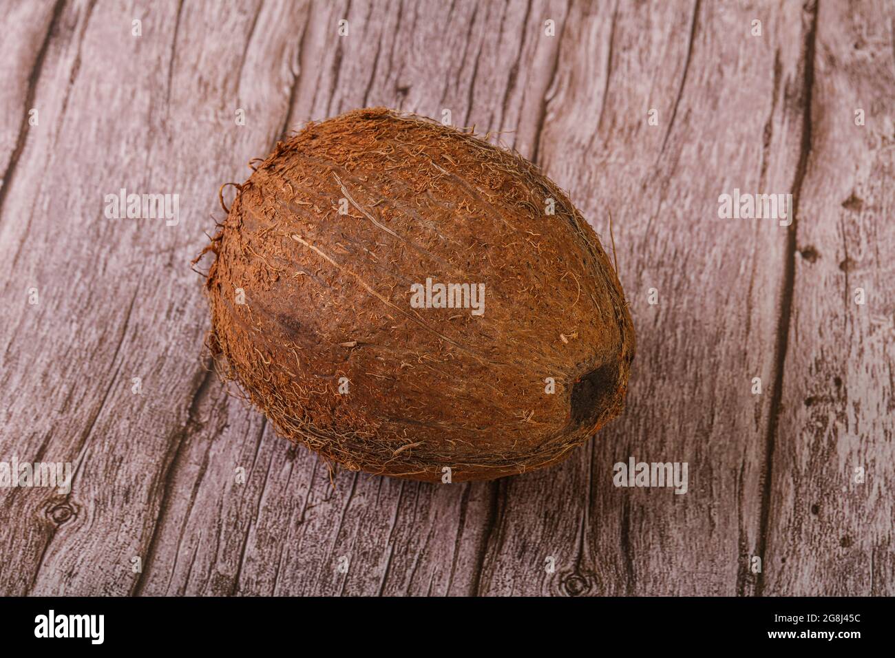 Tropical brown coconut over background isolated Stock Photo - Alamy
